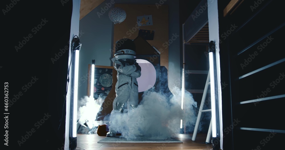 Cinematic shot, spaceman child in astronaut suit posing hands crossed ...