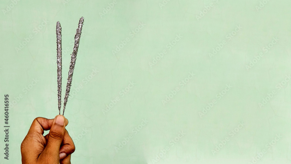 Diwali Cracker fuljhadi on clean background, Hand holding multiple ...