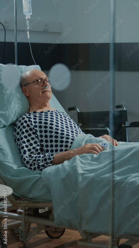 Old patient with breathing problems sitting in hospital ward for ...