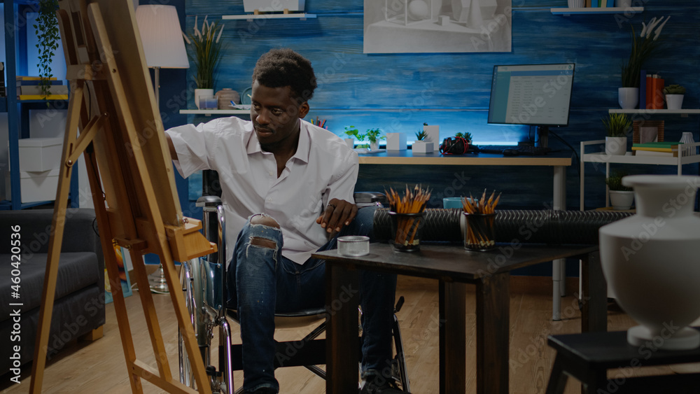 Disabled african american man using pencil for drawing design sitting ...