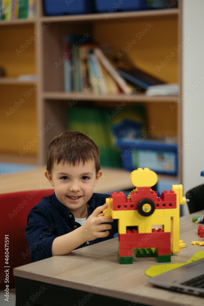 One kid choose parts of robotic electric toys for his age of four to ...