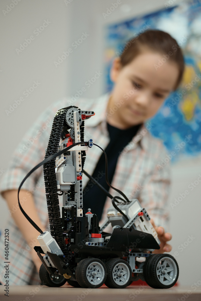 Boy Works on a Fully Functional Programable Robot for His School ...