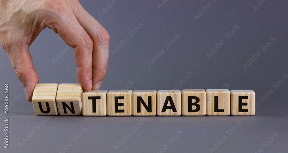 Tenable or untenable symbol. Businessman turns cubes and changes the ...