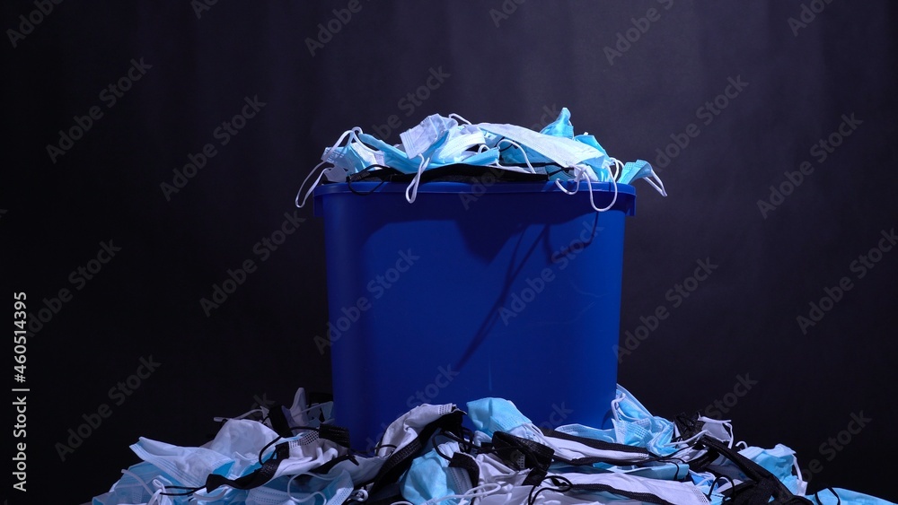 Stockfoto Medical masks in the recycle bin. Reusing and recycling of ...