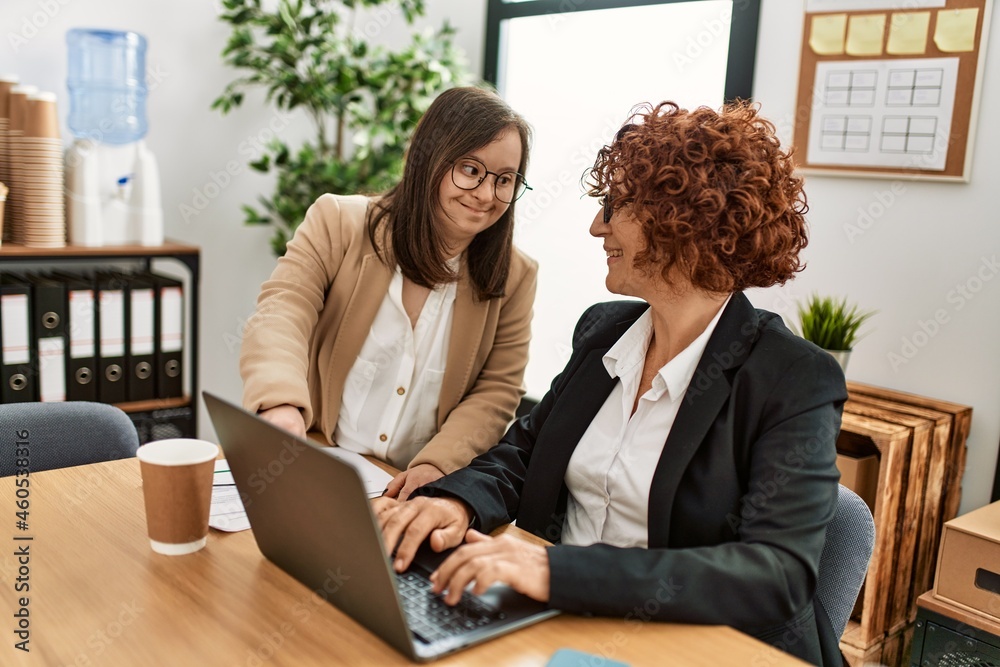 Group of two women working at the office. Mature woman and down ...