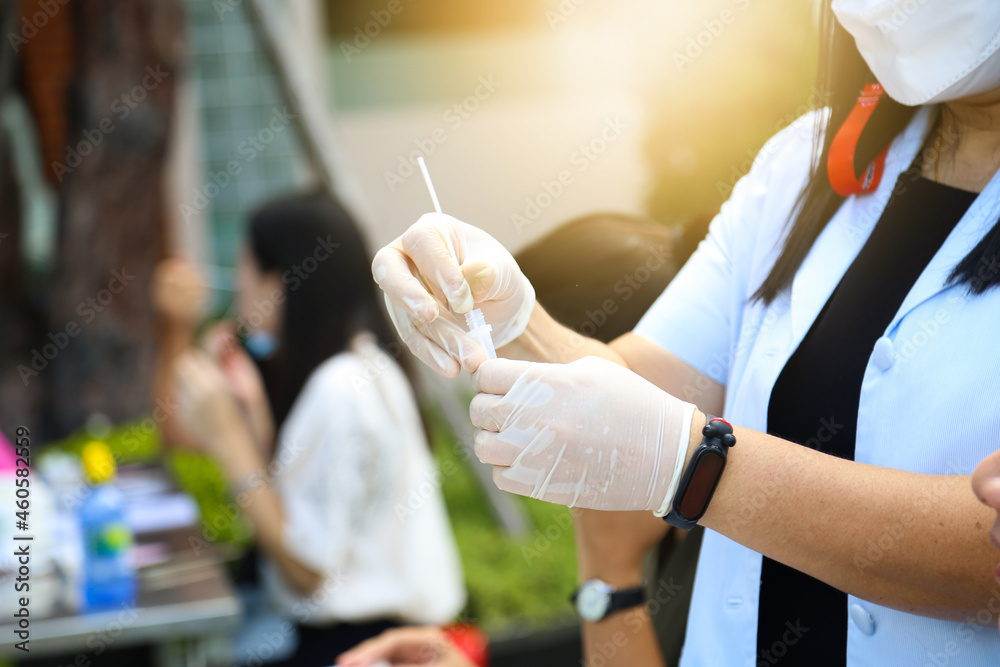 People swab COVID-19 testing by Rapid Antigen Test kit before working ...