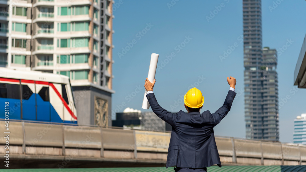 Success businessman engineer hold winner fist pump blueprint punching ...