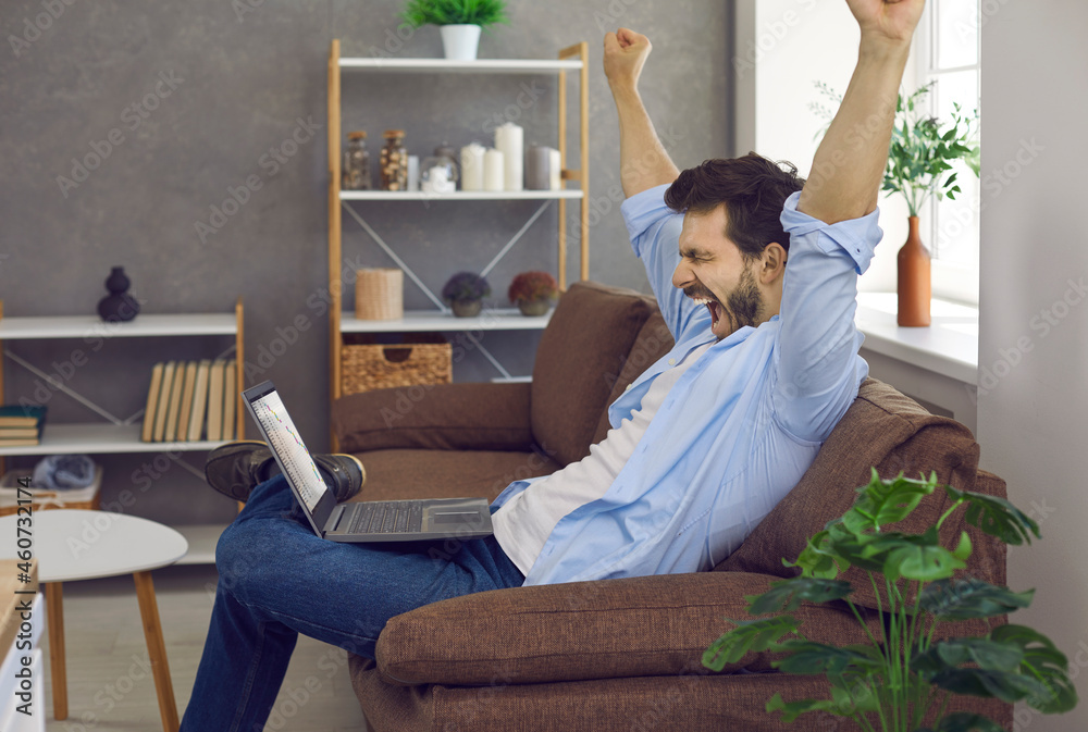 Sleepy tired young man yawning while working on laptop computer in home ...