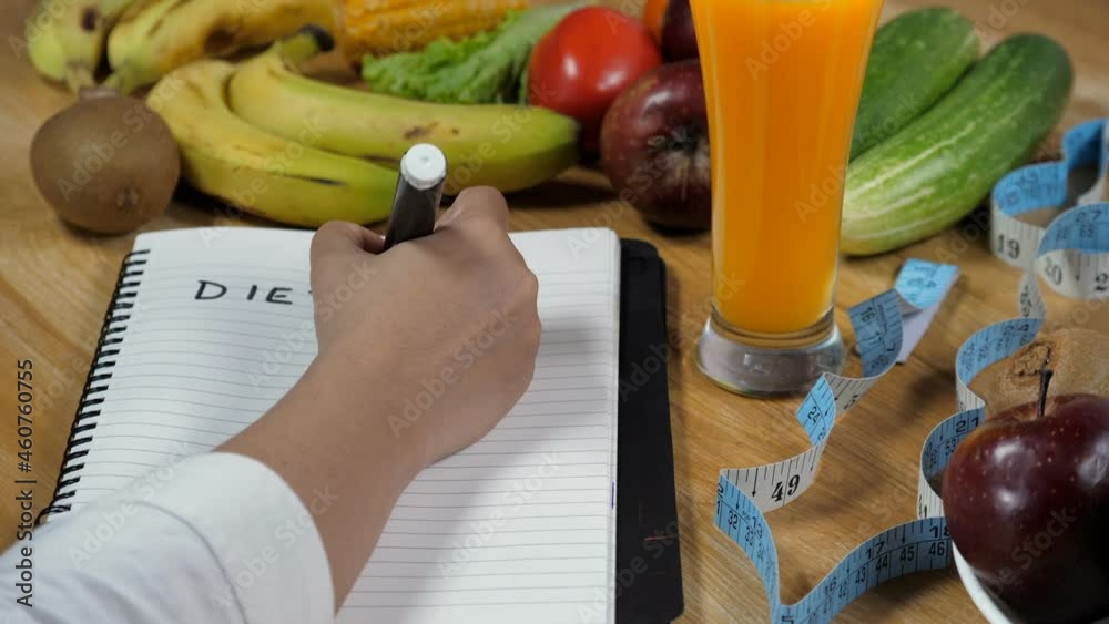 Nutritionist making a "Diet Plan" for weight loss journey . Fruits ...