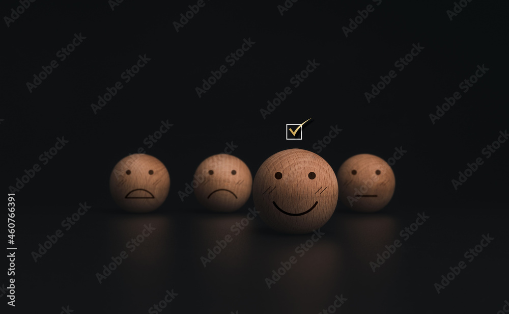 Check mark a checkbox on smiley emoticon face on the wooden balls on ...