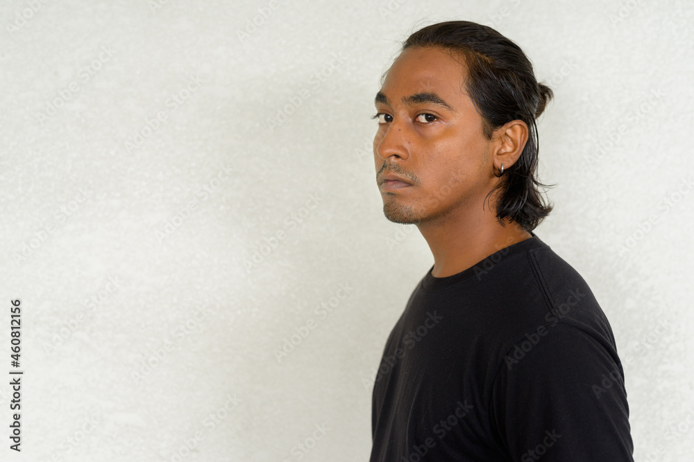 Profile view portrait of handsome young Indian man against plain ...