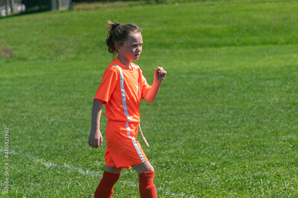 Young girl on Soccer Field running. Granddaughter in youth sports in ...
