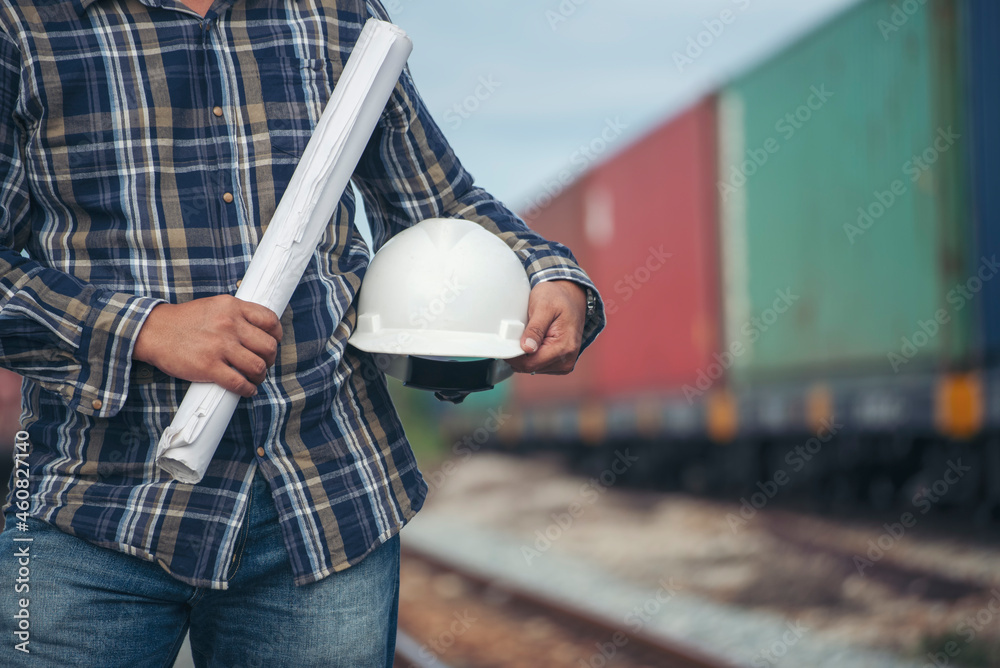 Hand of man engineer holding safety hat and blue print and inspect in ...