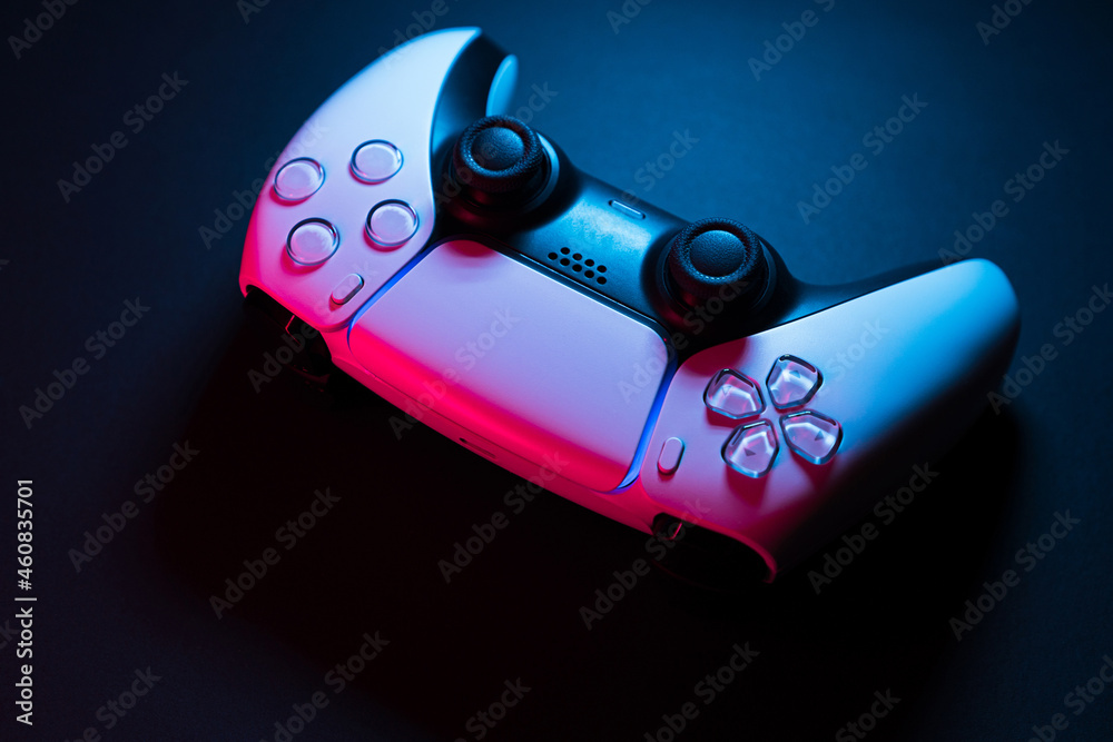 Next generation white game controller isolated on black background with ...
