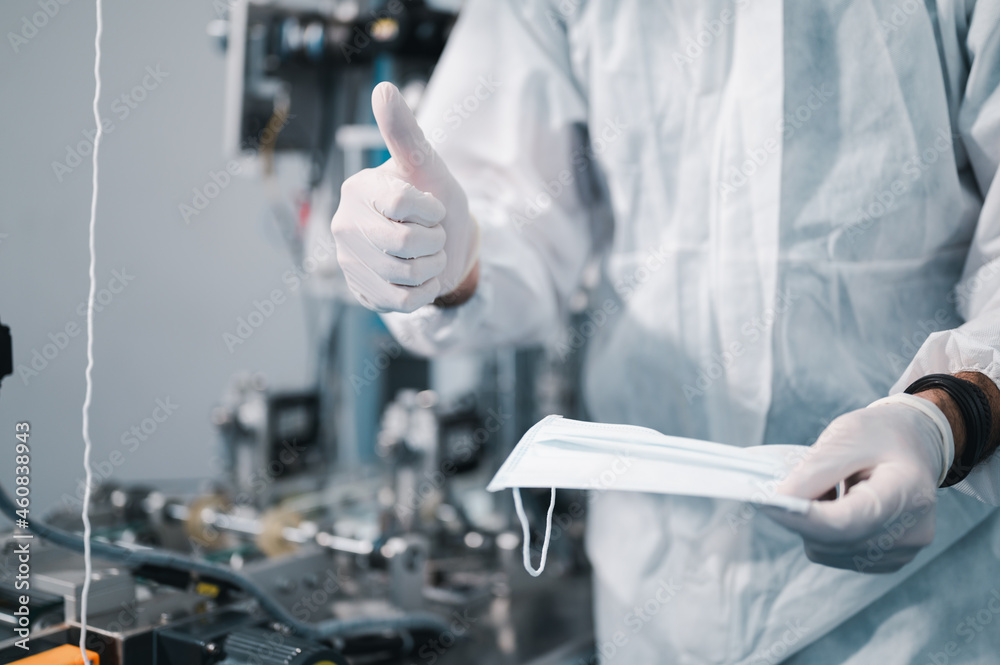 Scientists wearing uniform protection. Check the manufacturing process ...