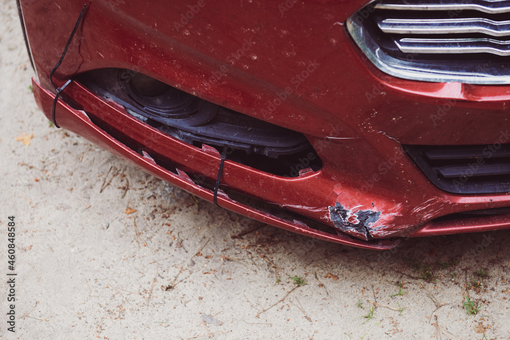 Dented front bumper. Self-repaired with yoke damaged red car. Off-road ...