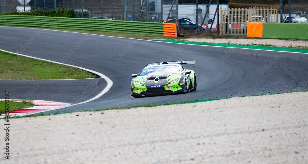 Fast gt race car on asphalt track high speed turn front view ...