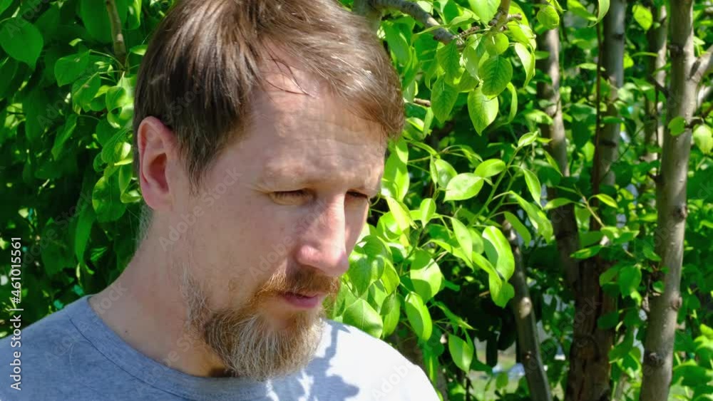 Insects bite man outdoors. 50 year old man wards off mosquitoes and ...