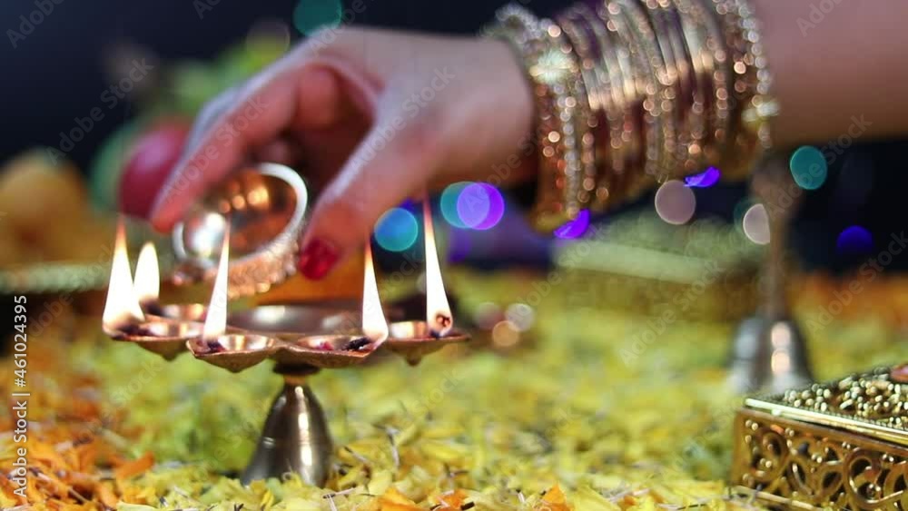 Illuminated Brass Diya With Flames And Gift Boxes On Yellow Marigold Flower. Hands Of Married ...