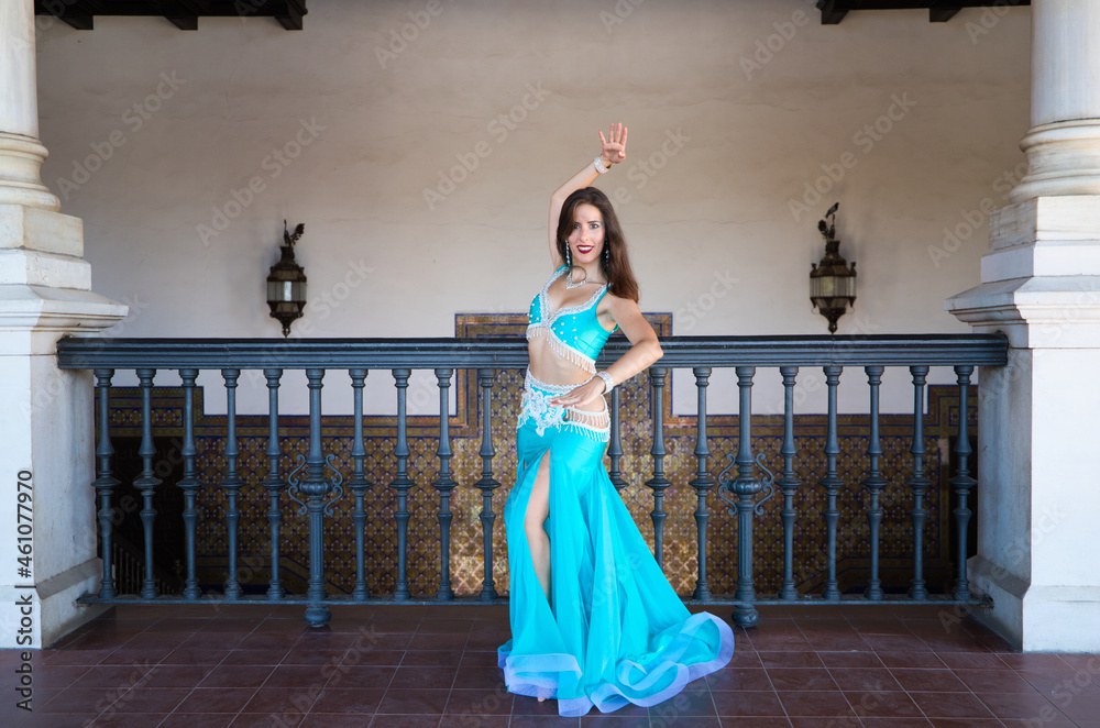 beautiful young belly dancer is posing for the camera in a photo shoot ...