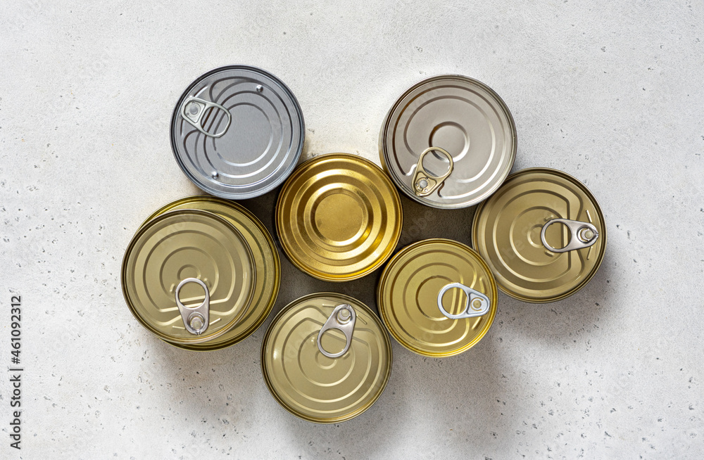 Various tin cans for food preservation on gray concrete background top ...