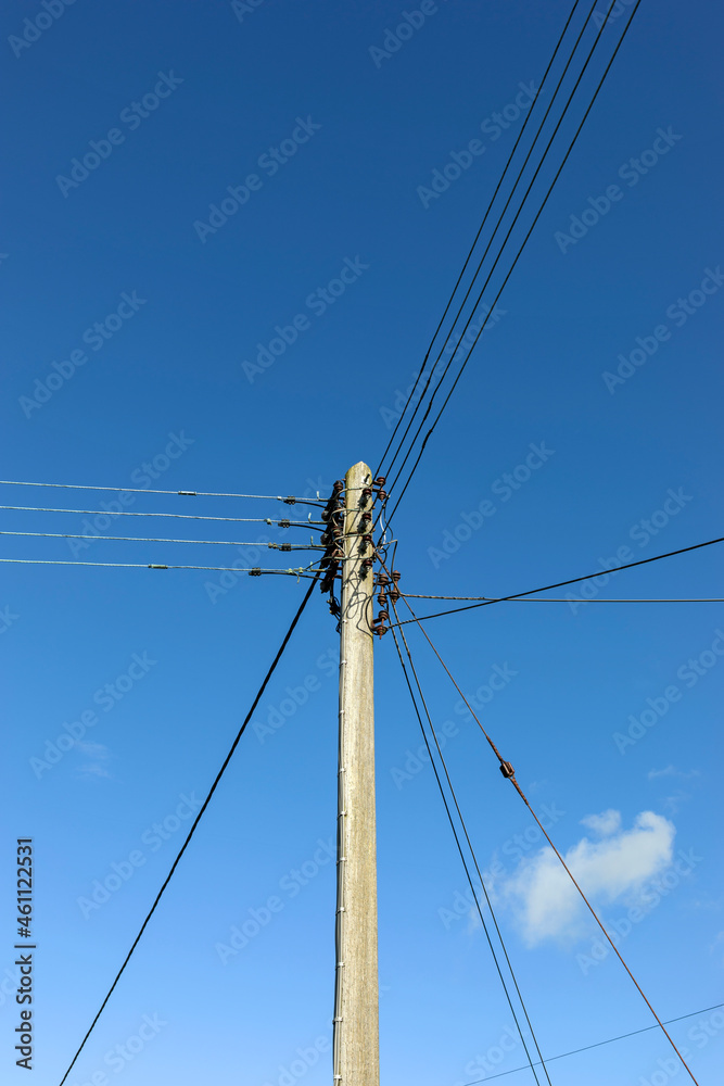 Overhead cables carrying mains electricity to houses in the suburbs of ...