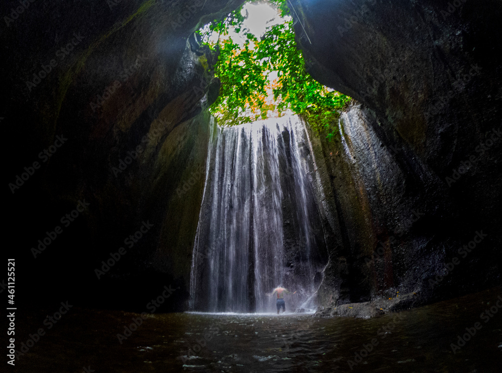 View of Tukad Cepung waterfall hidden in a cave located at Tembuku ...
