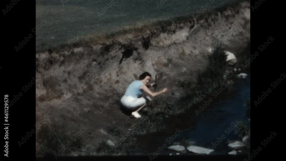 Found Ball 1958 - A woman finds her golf ball in a water hazard. Stock ...