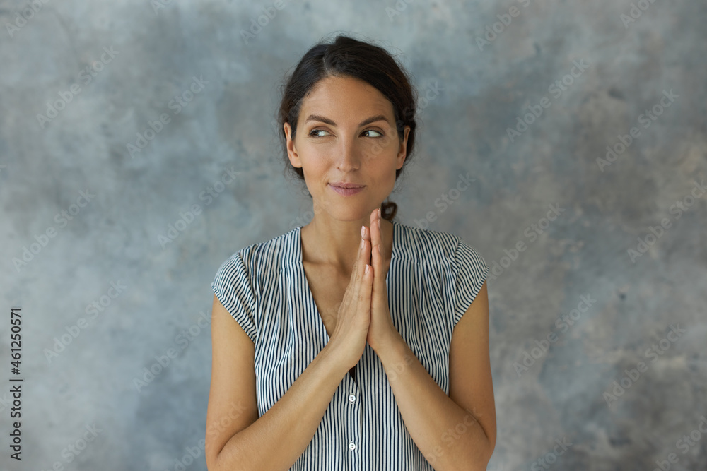 Indoor studio picture of sly-looking young attractive woman rubbing ...