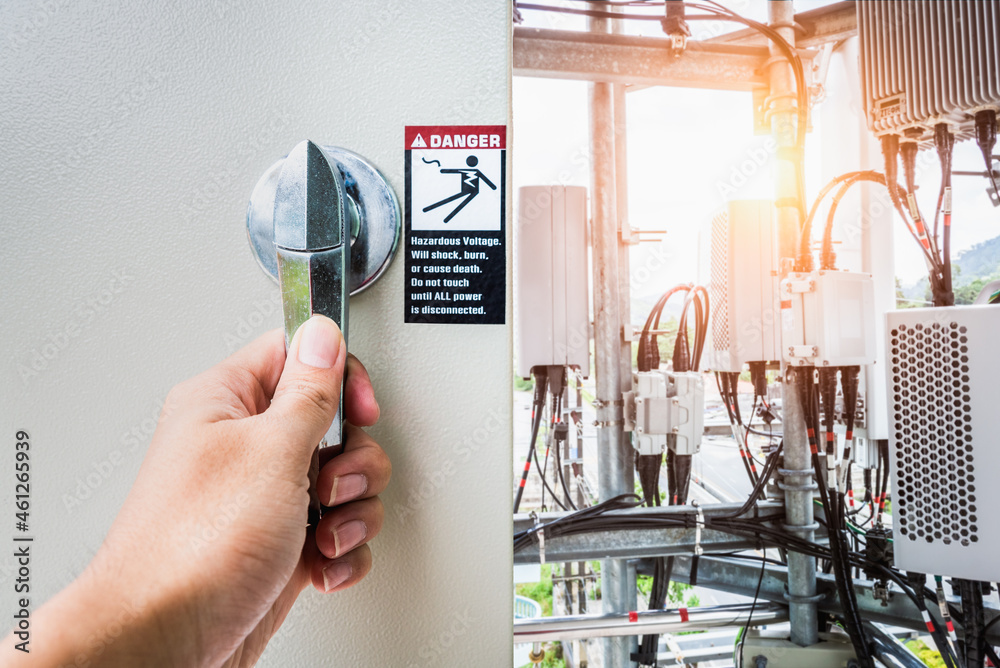 Engineer hand holding open electric power control box checking ...