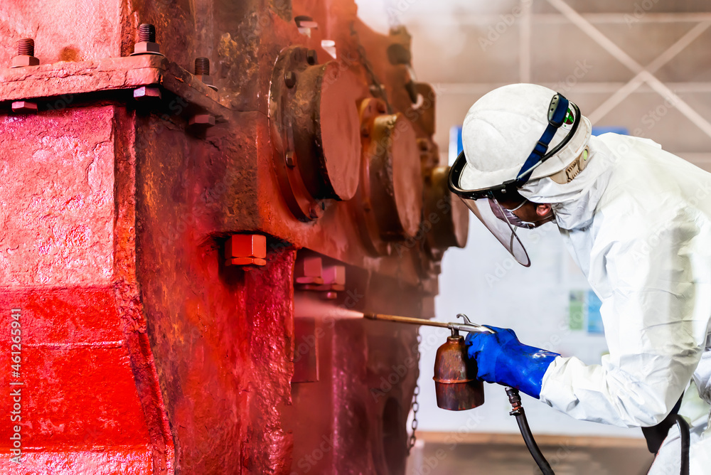 Airless Spray Painting, Worker painting on heavy gear machine steel ...
