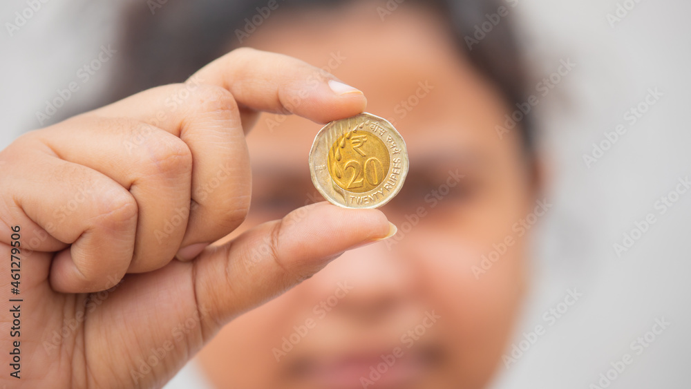 Indian girl showing tail side of twenty-rupee coin Stock Photo | Adobe ...