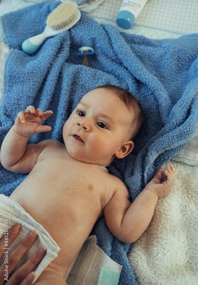Newborn Baby Getting a Diaper Change After a Bath at Home. An anonymous ...