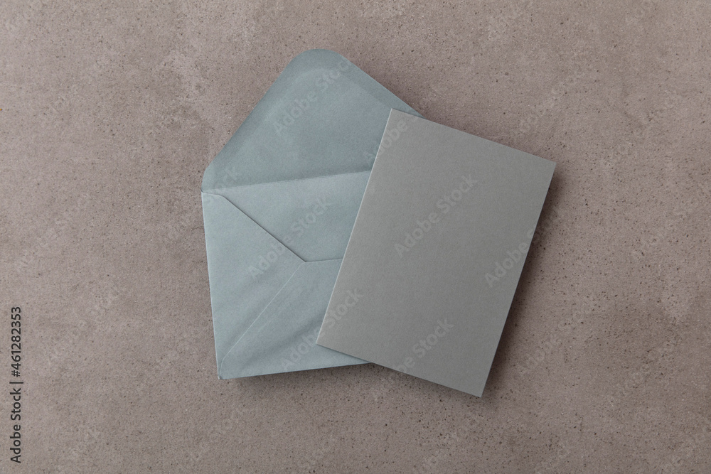 Blank grey card with grey paper envelope template mock up on a concrete ...
