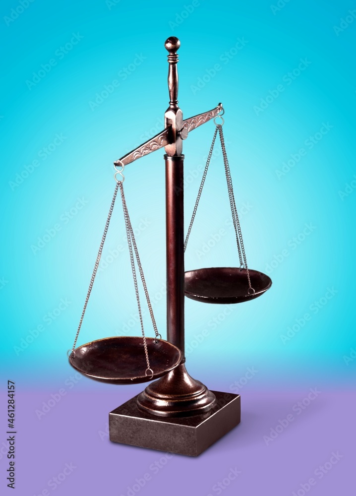 A stylish weigh scale on the desk with two arms of a chained bucket ...