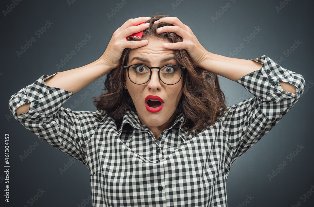 Panicked young woman with open mouth stare to you with popped eyes over ...
