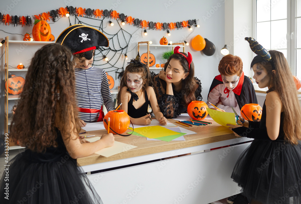 DIY activities for Halloween. Group of children together withwoman ...