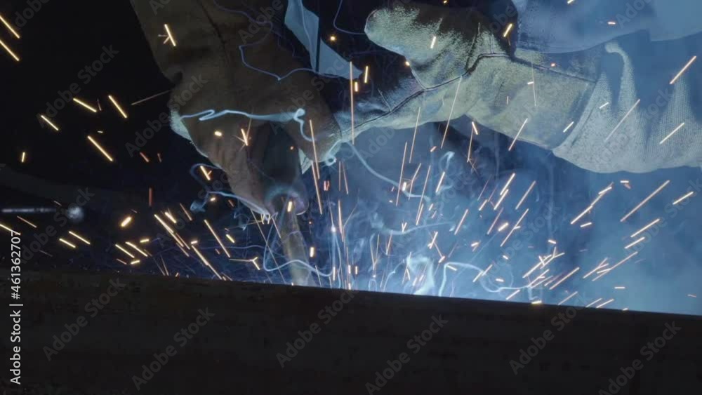 Worker's Hands In Protective Gloves Hold A Soldering. Welding Process ...