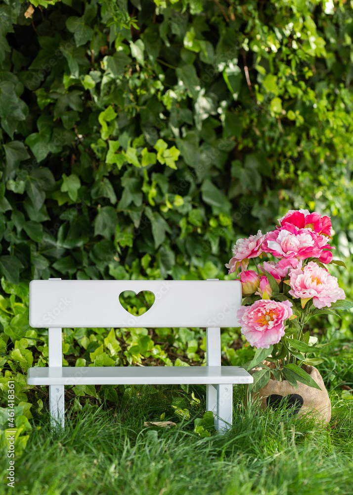 mini baby bench with pink flowers in a park Stock Photo | Adobe Stock