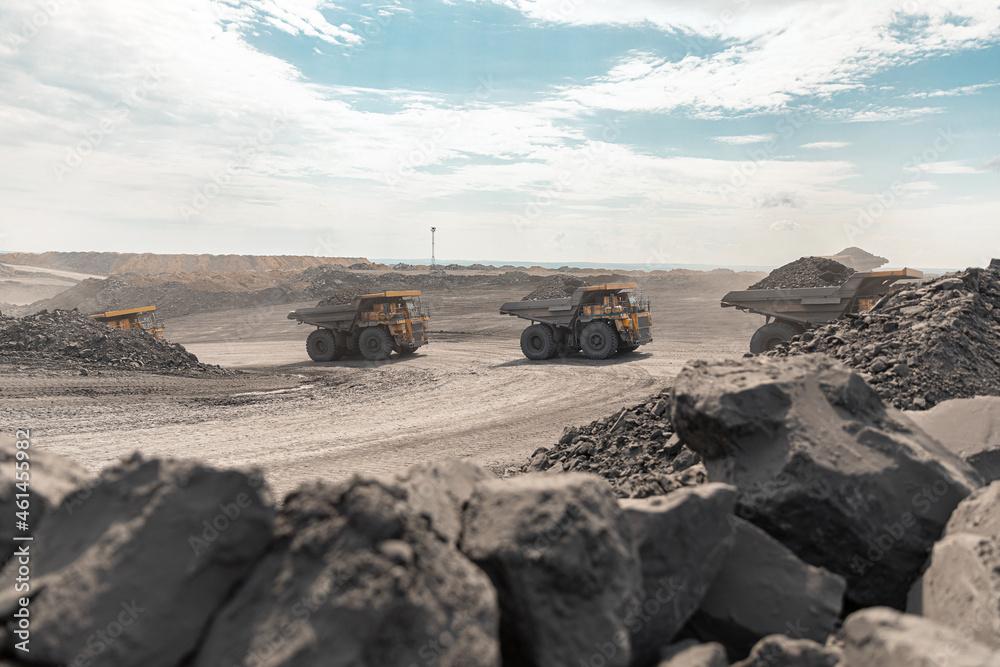 Large quarry dump truck. Big yellow mining truck at work site. Loading ...