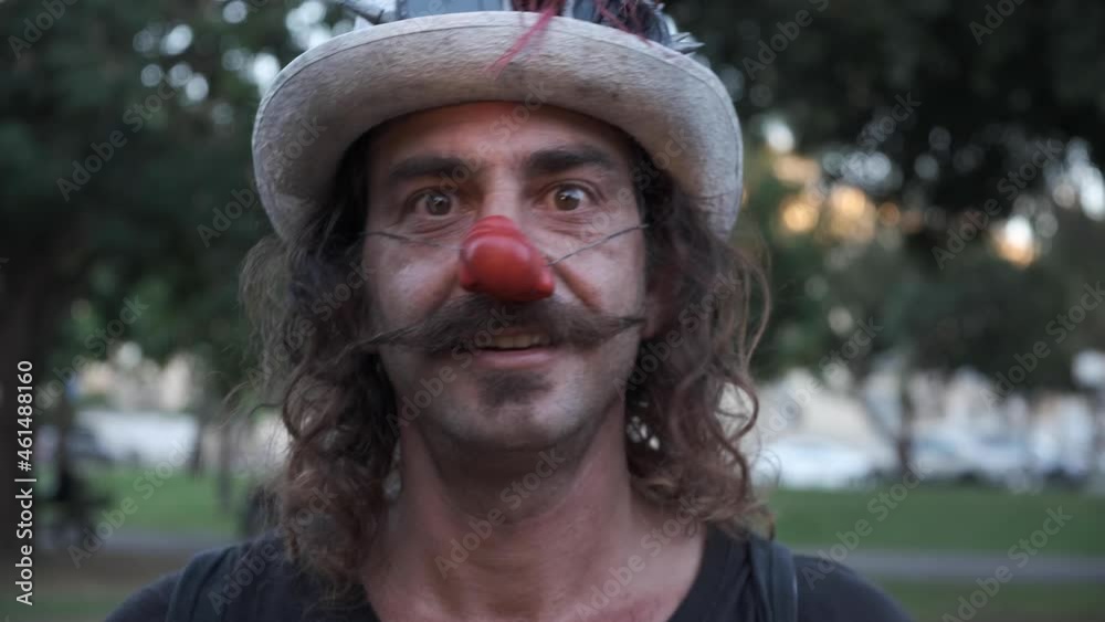 Clown playing with mustache and smiling to camera. Steampunk dirty ...