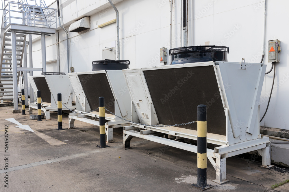 Air conditioner compressor installed in old building. Cooling towers in ...