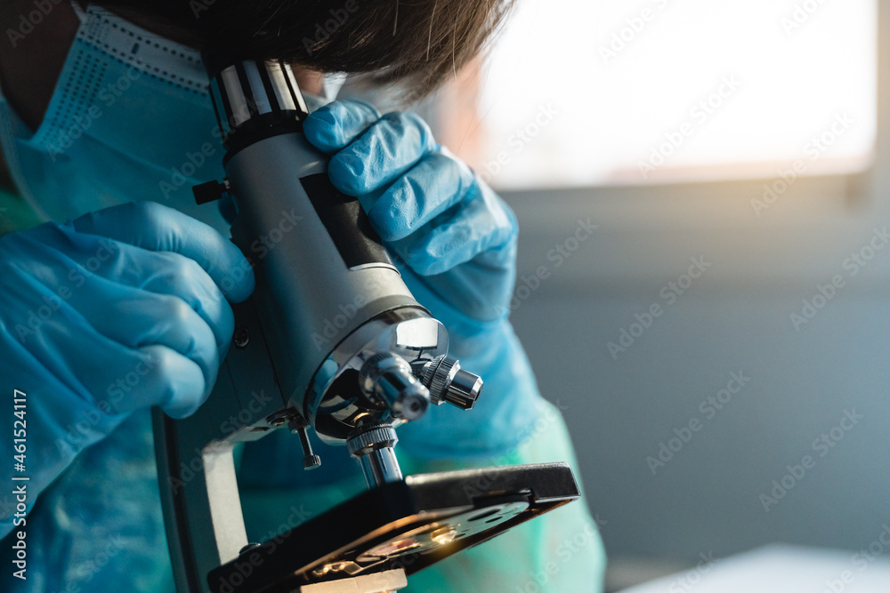 Medical doctor working on microscope inside laboratory during ...