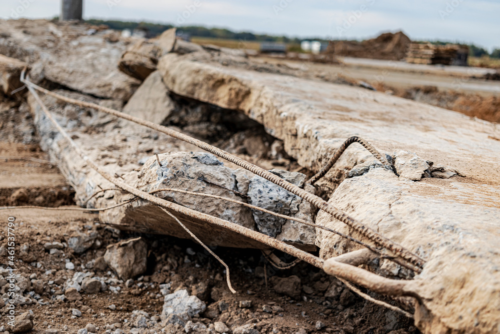 An old broken reinforced concrete slab with protruding reinforcement ...