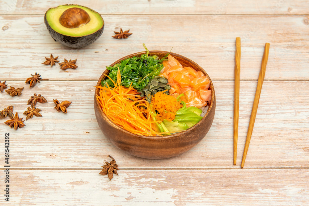 Salmon poke bowl with pumpkin seeds, white rice, ripe guacamole, grated ...