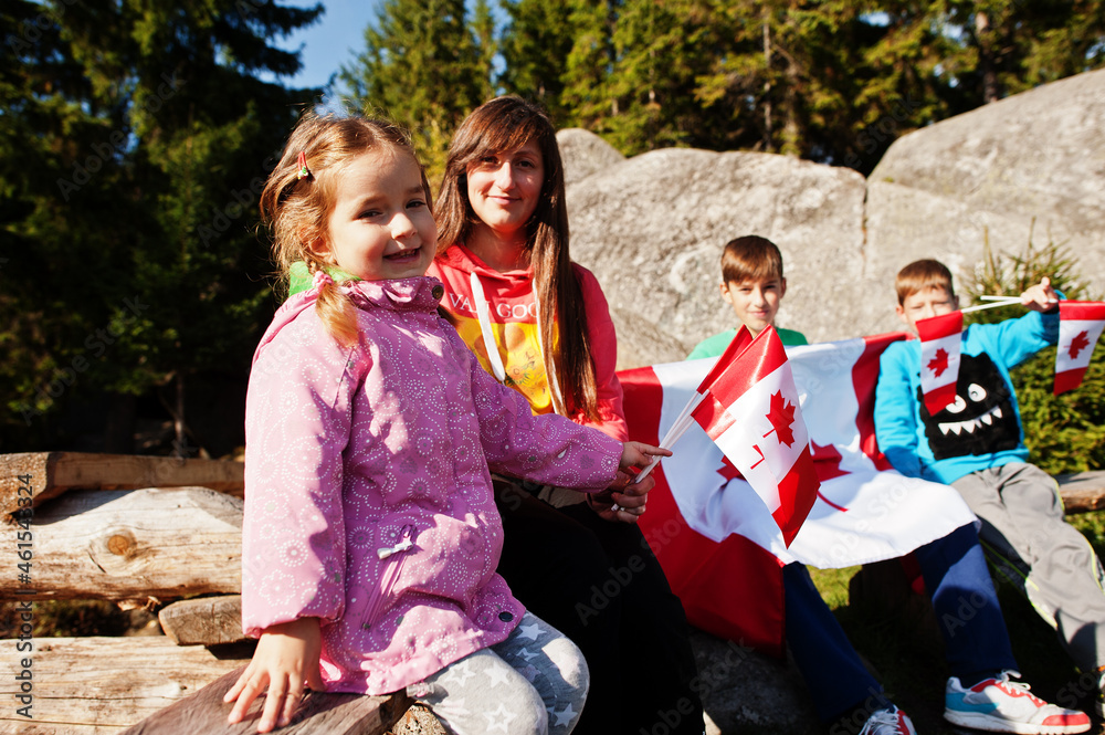 Happy Canada Day. Family of mother with three kids hold large Canadian ...