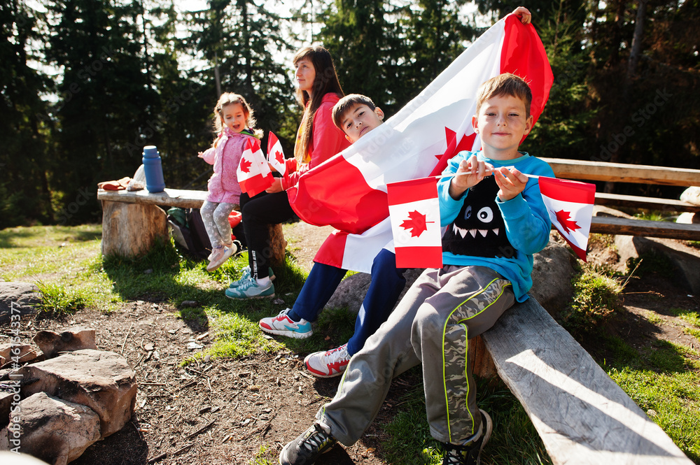 Happy Canada Day. Family of mother with three kids hold large Canadian ...