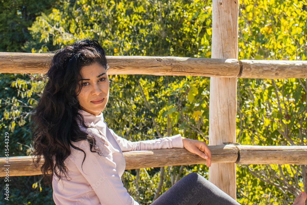 lovely young girl enjoying a relaxing day in nature while relaxing in a ...