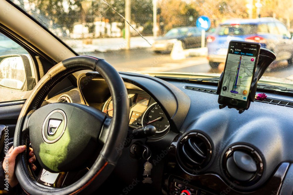 Using waze maps application on smartphone in car dashboard. Driver ...