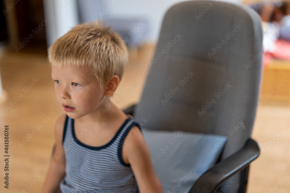Child sitting on chair in front of monitor computer Stock Photo | Adobe ...